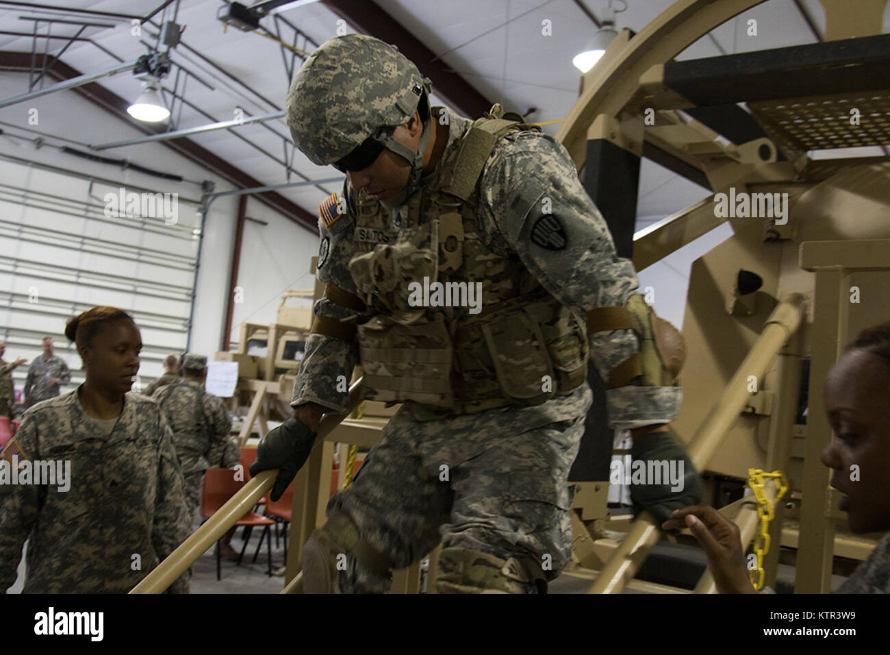 Staff Sgt. Jose Santos exits a HMMWV Egress Assistance Trainer (HEAT ...