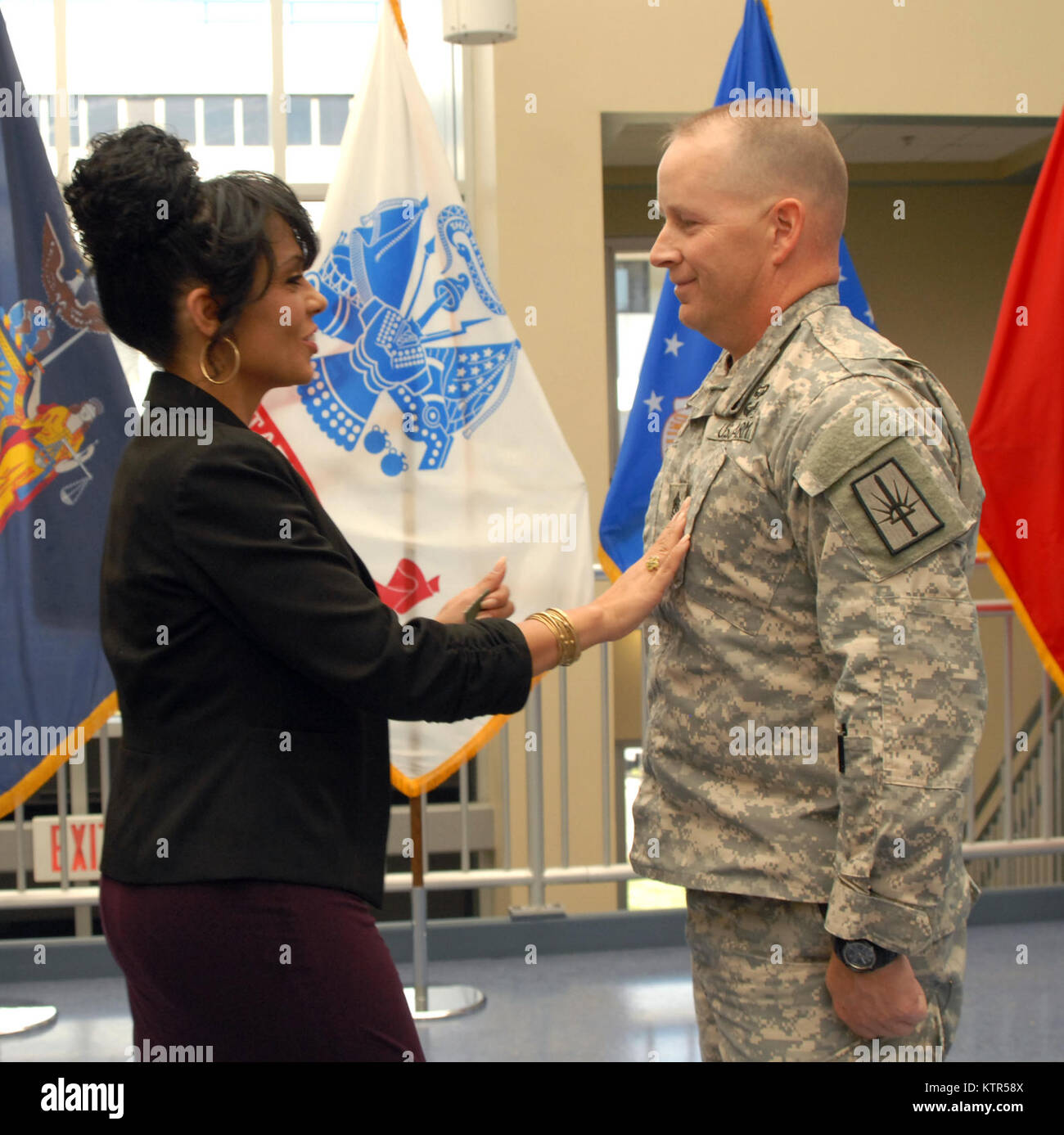 LATHAM, N.Y -- Alicia Lunny (left) attaches sergeant major rank ...