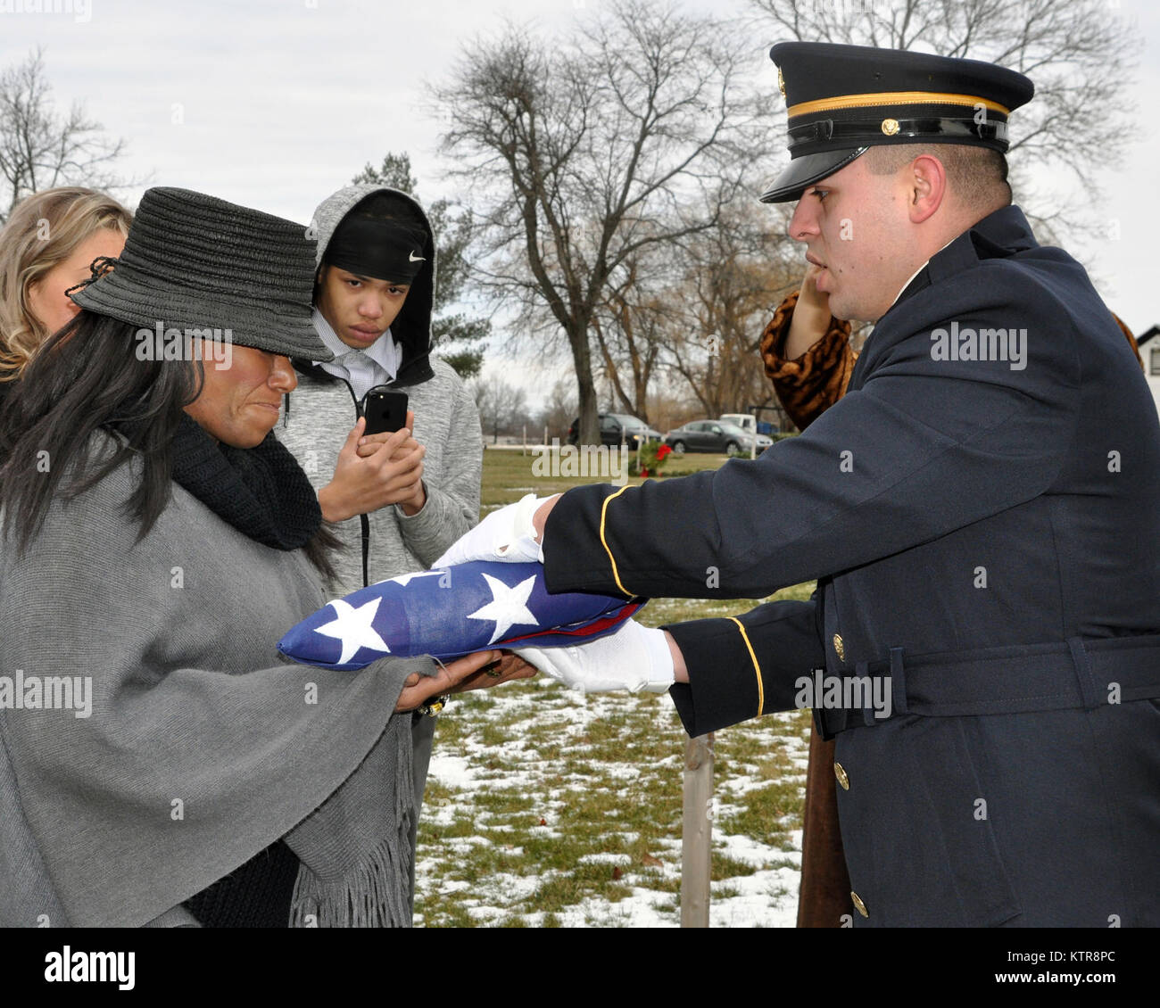 New York Army National Guard Spc. Ramon Rodriquez, presents a U.S. Flag ...