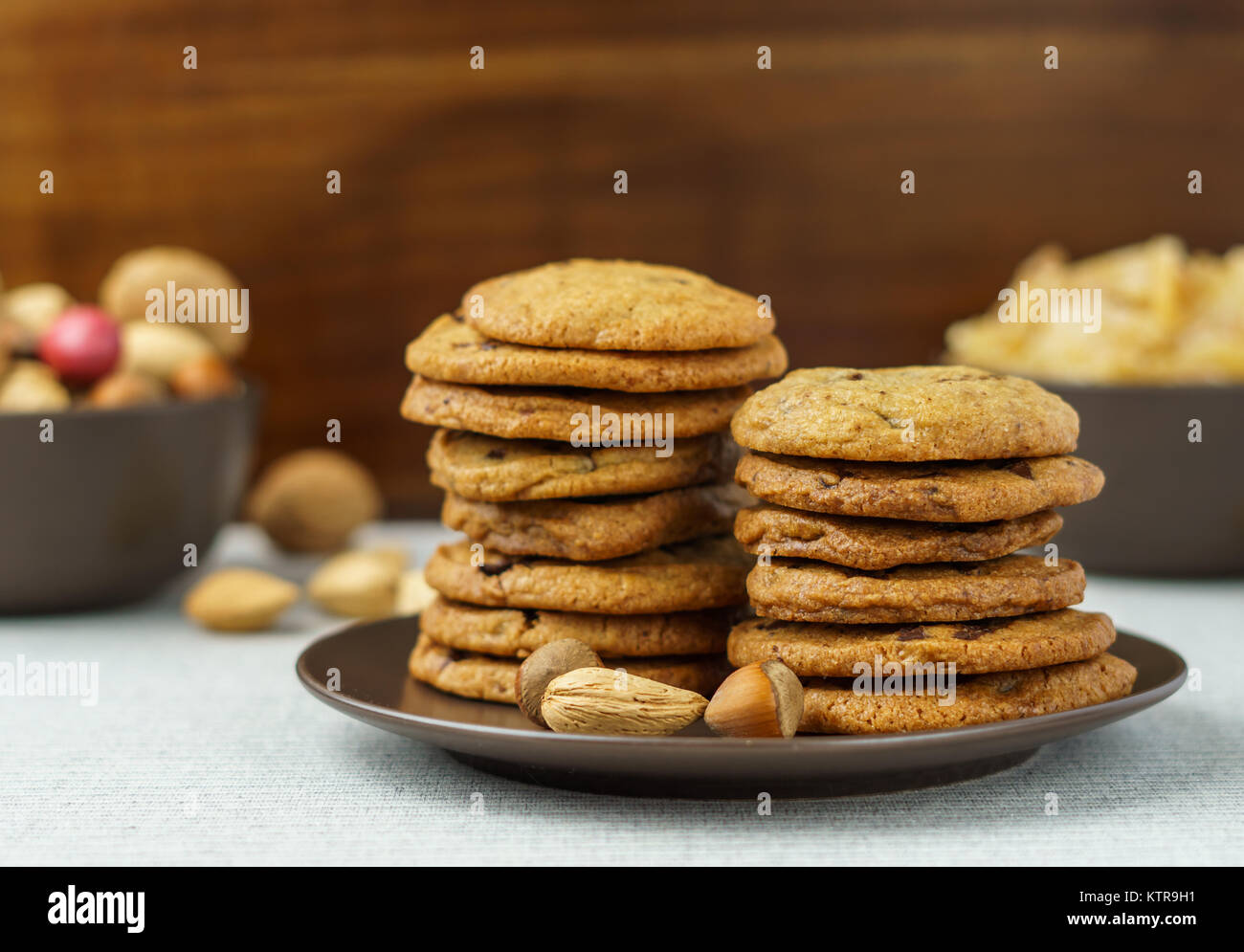 freshly baked chocolate chip cookies on a table with blurred background ...