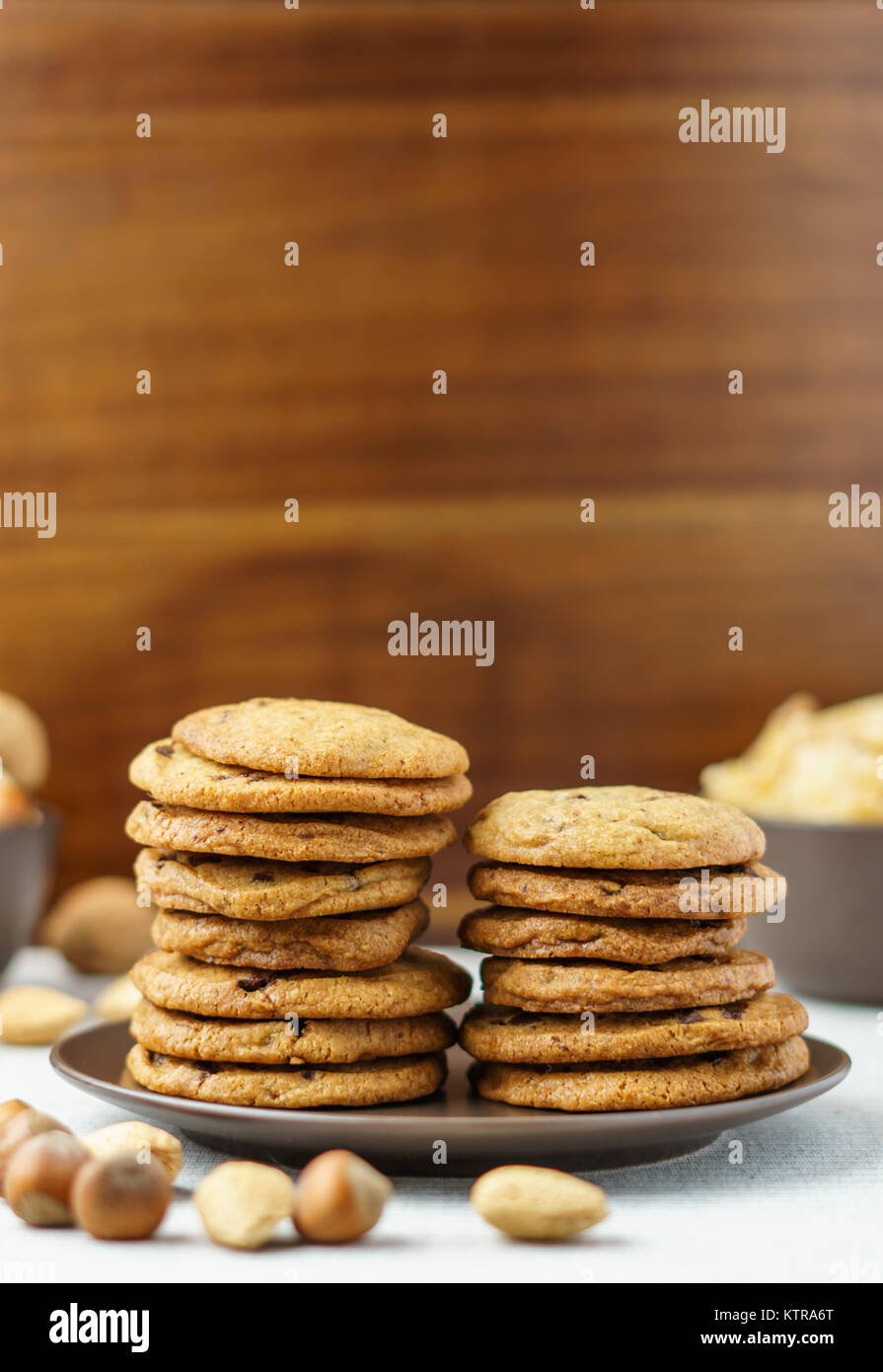 freshly baked chocolate chip cookies on a table with blurred background ...