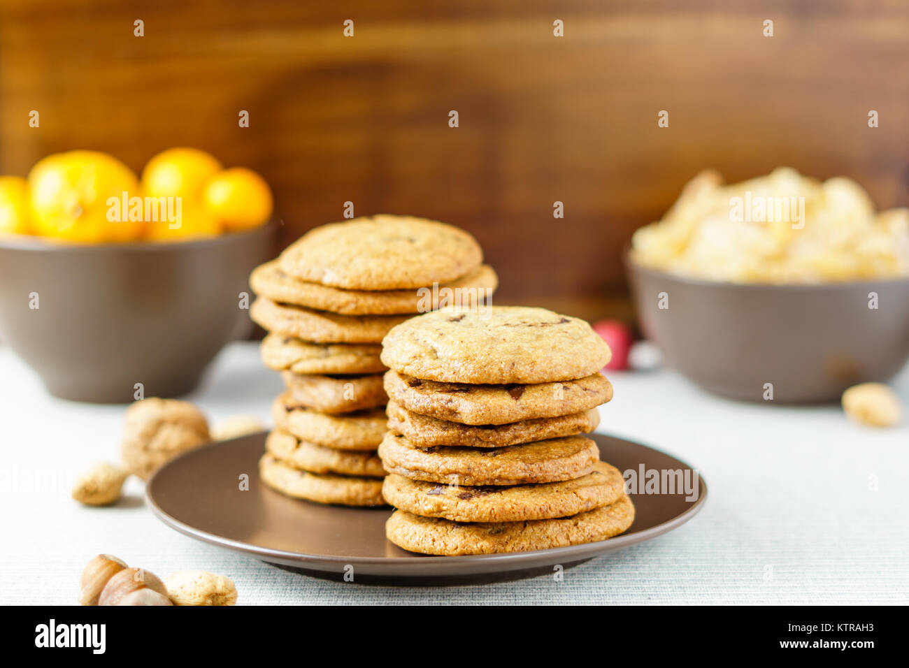 freshly baked chocolate chip cookies on a table with blurred background ...