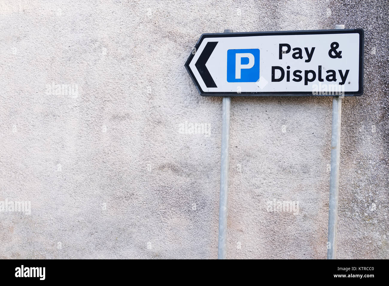 Pay and Display Sign on Wall with Directions given by Arrow Stock Photo ...