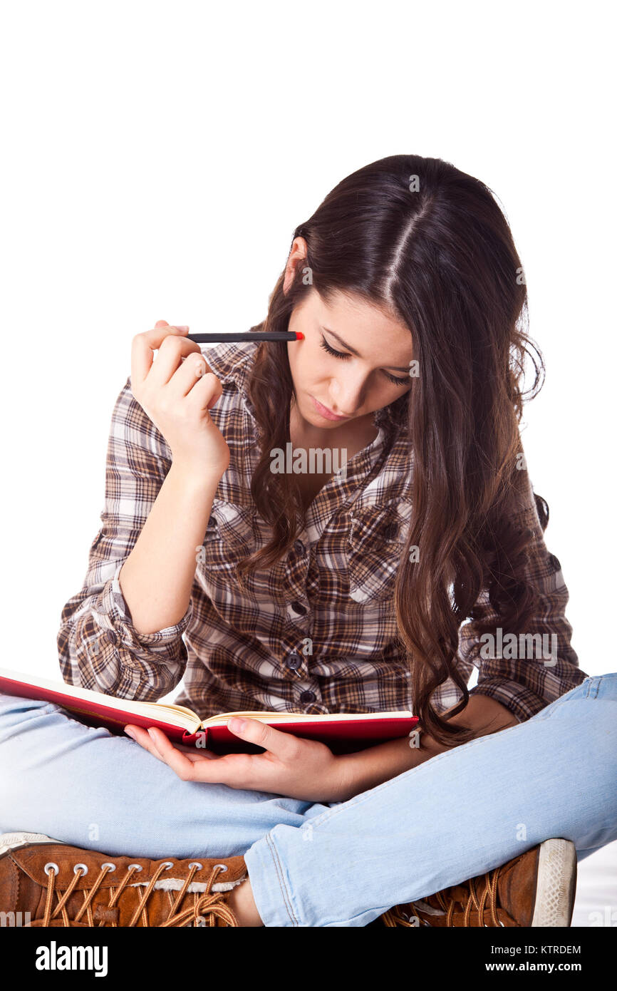Beautiful female student studying on floor isolated on white background ...