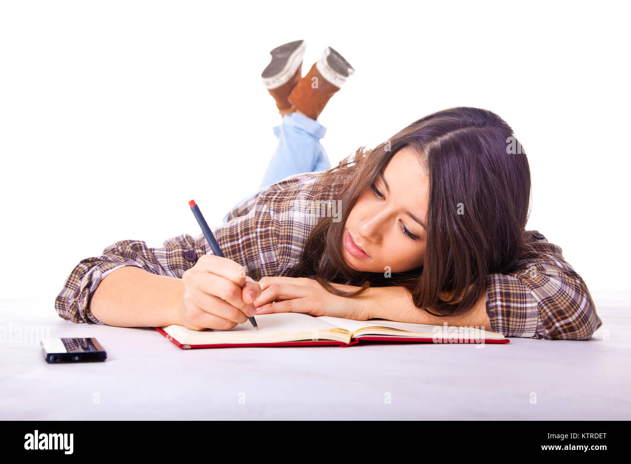 Beautiful female student studying on floor isolated on white background ...