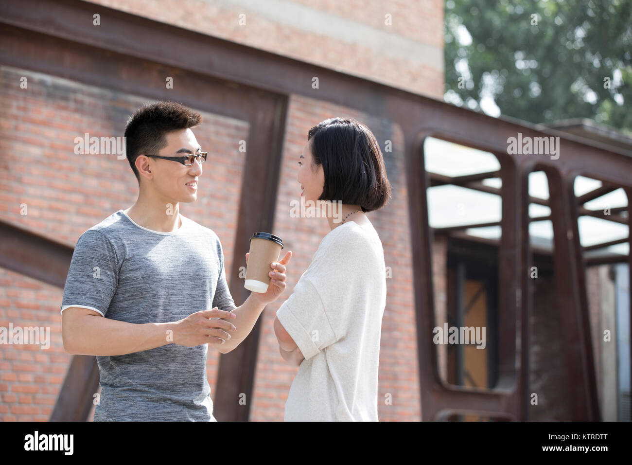 Young couple talking outdoors Stock Photo - Alamy