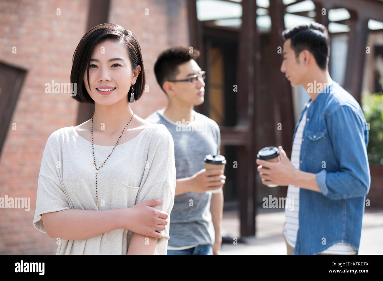 Cheerful young friends talking outdoors Stock Photo - Alamy