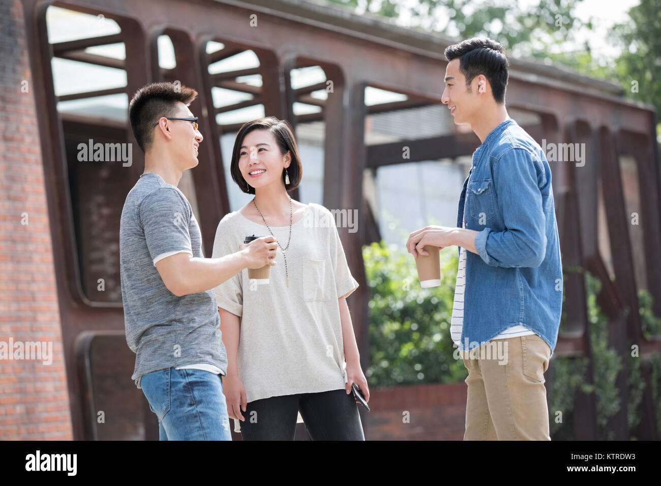 Cheerful young friends talking outdoors Stock Photo - Alamy