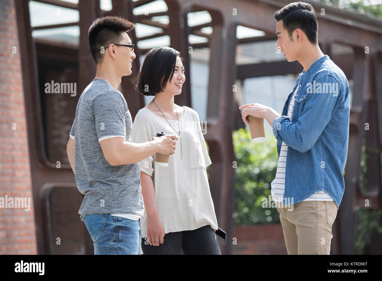 Cheerful young friends talking outdoors Stock Photo - Alamy