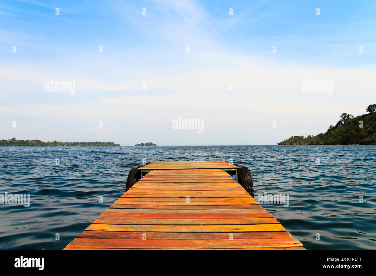 Wooden dock on a beautiful blue lake Stock Photo - Alamy