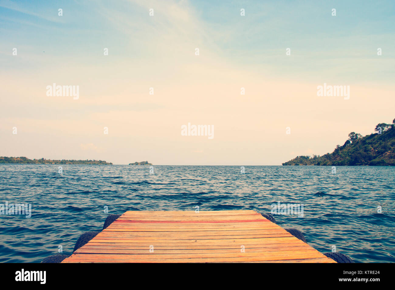 Dock extending out into beautiful blue water, vintage effect Stock ...