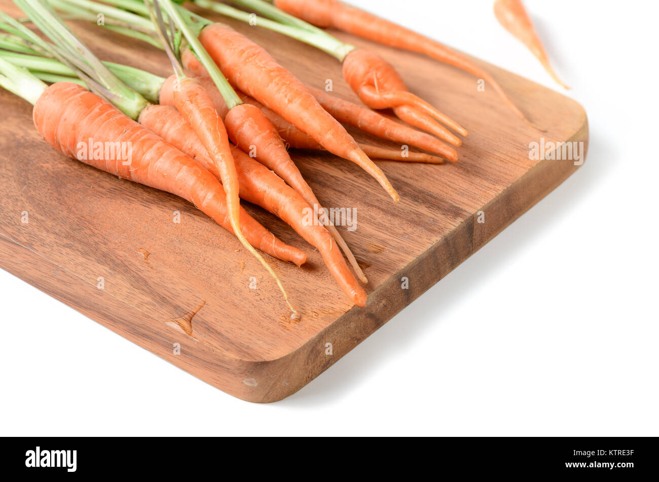 fresh carrot, baby carrot on wood block isolated on white background ...