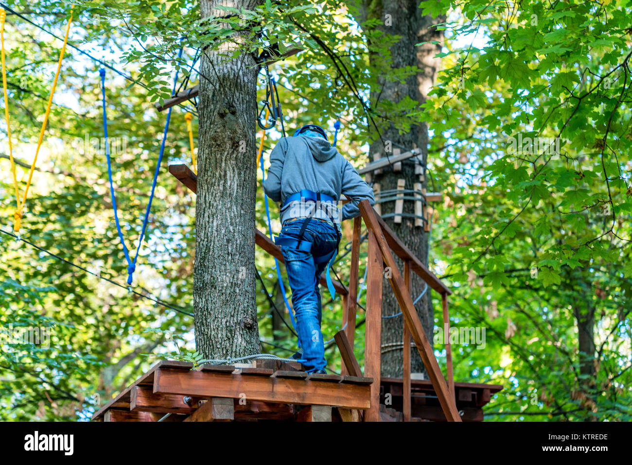 Back view man in adventure park Stock Photo - Alamy