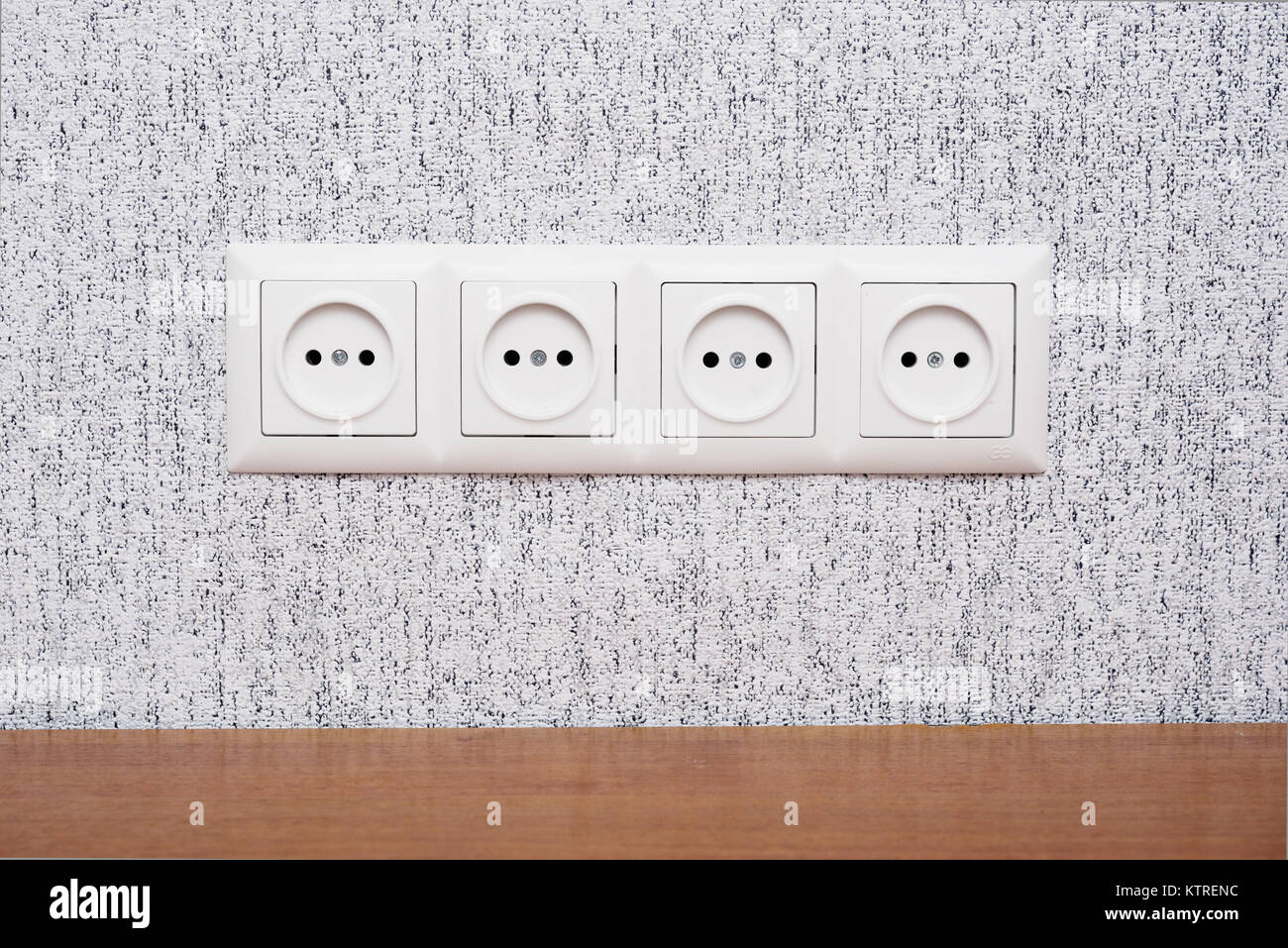 Four electrical sockets on a wall Stock Photo - Alamy
