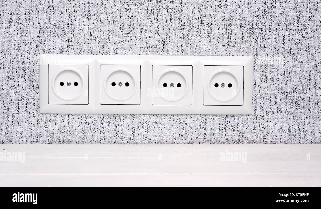 Four electrical sockets on a wall Stock Photo - Alamy