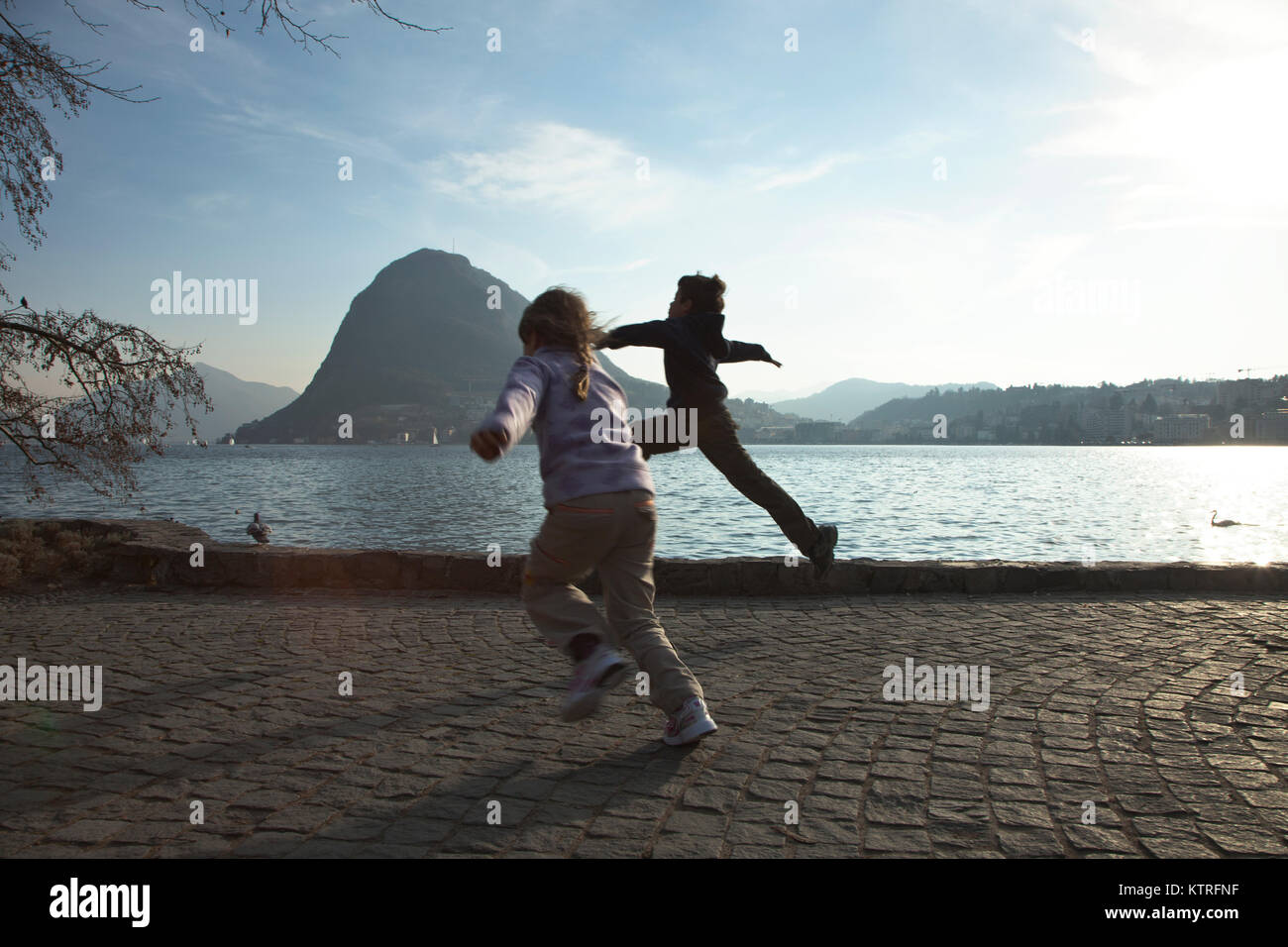 children running near a lake Stock Photo - Alamy