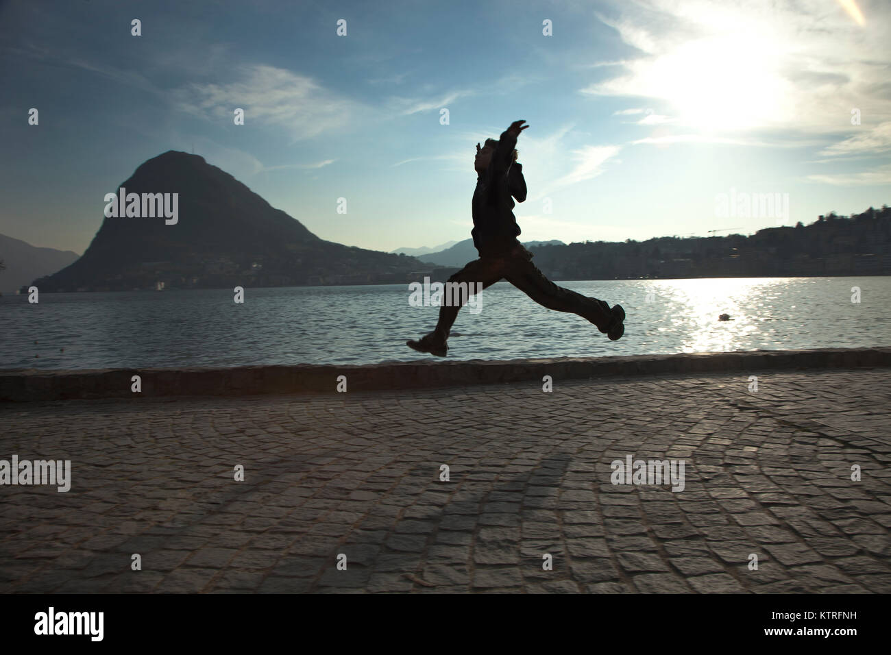 children running near a lake Stock Photo - Alamy