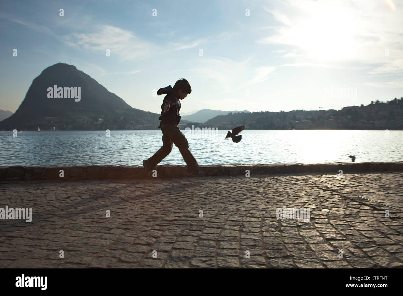children running near a lake Stock Photo - Alamy