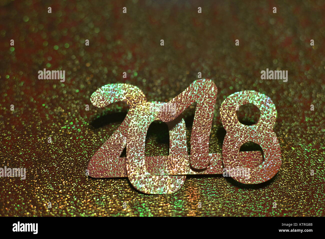 Number 2018 on glittering underground. New year numbers in pink color ...
