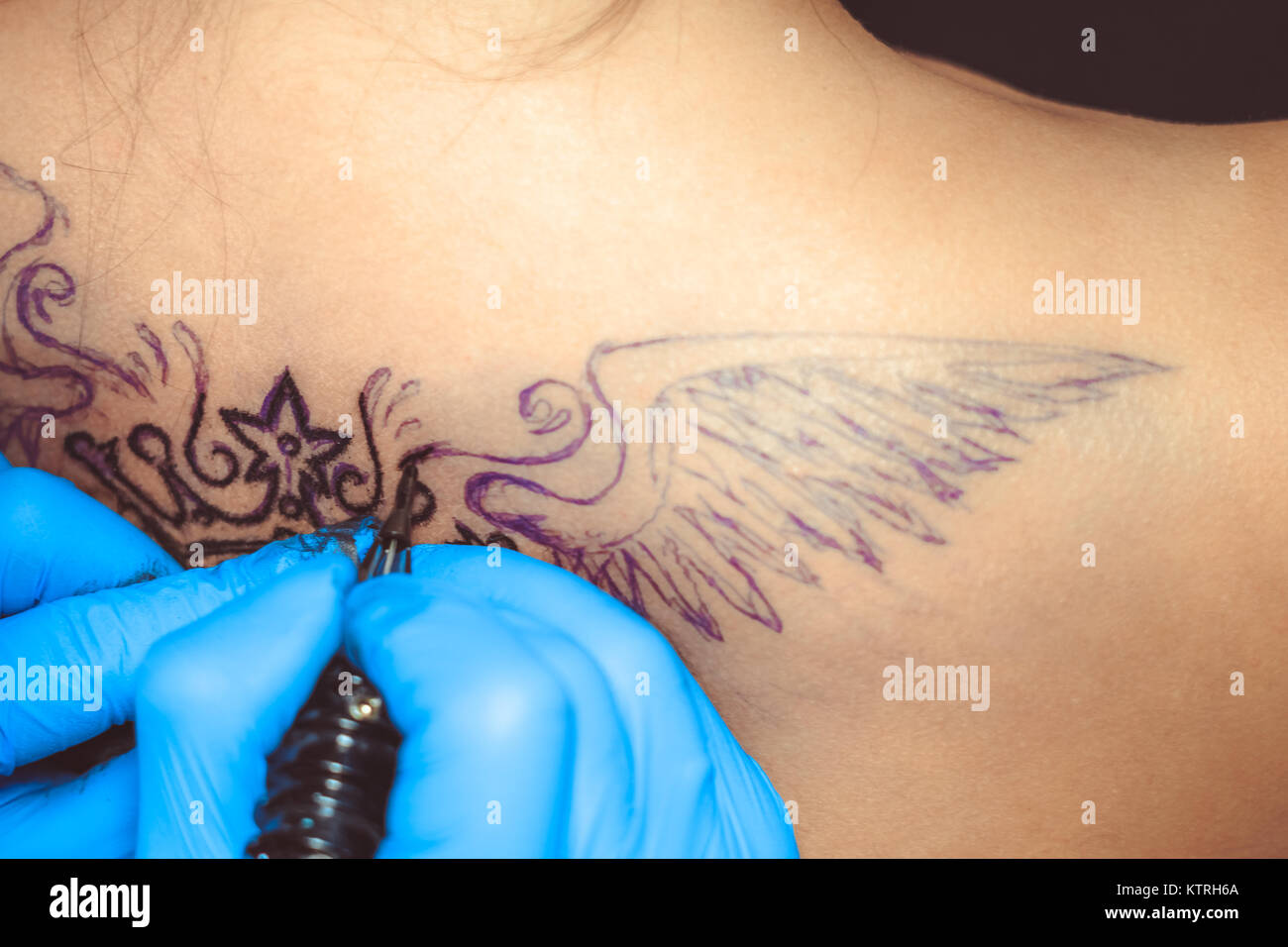 tattooer showing process of making a tattoo hands holding a tatoo ...