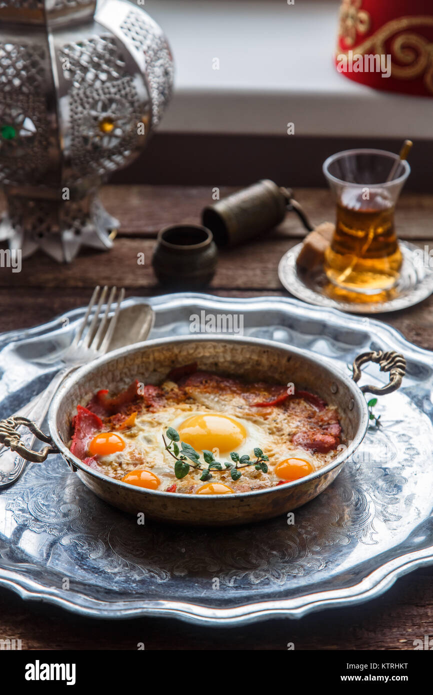 Copper pan with fried eggs and sausages, turkish style Stock Photo - Alamy