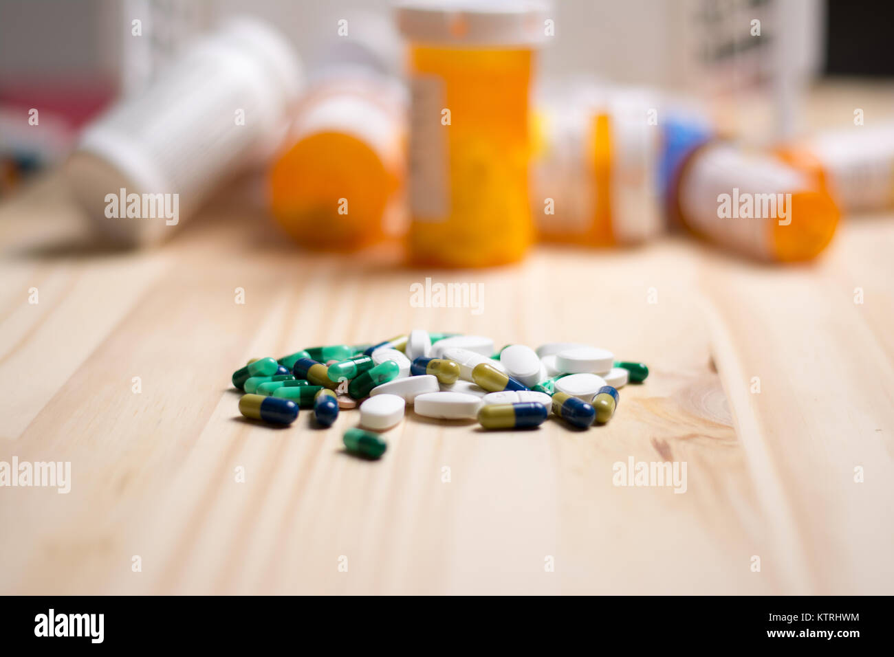 assortment of pharmaceutical drugs with pill bottles in the background ...