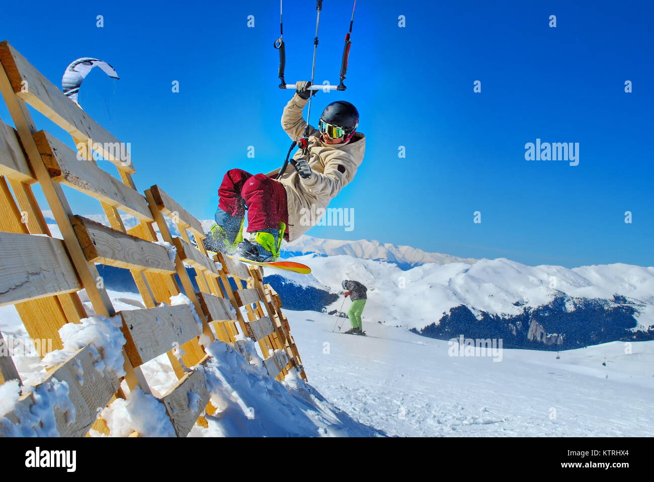 athlete snowboarder doing snowkiting on the snow in the mountain Stock ...