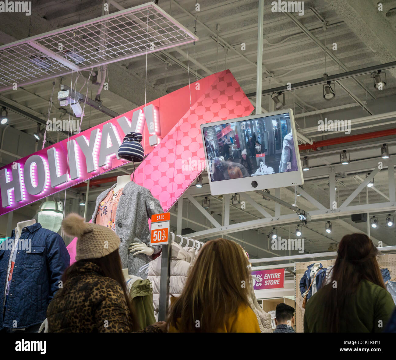 A monitor shows the video feed of a security camera at the entrance to ...