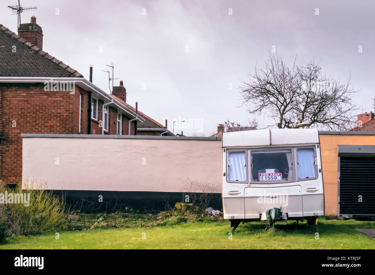 Caravan for sale outside brick houses Stock Photo - Alamy