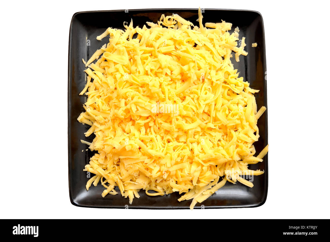 Isolated image of grated hard cheese on a black square plate. Top view ...