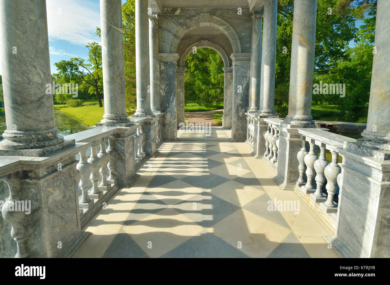 A beautiful marble bridge on the lake has a classic architectural ...