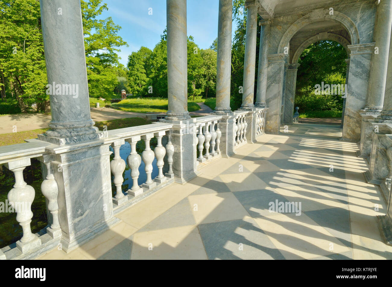 A beautiful marble bridge on the lake has a classic architectural ...
