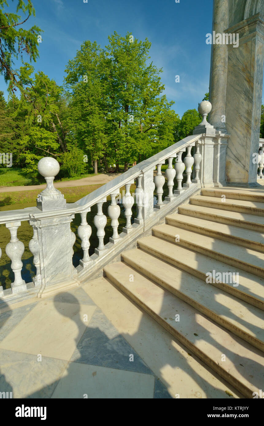 A beautiful marble bridge on the lake has a classic architectural ...