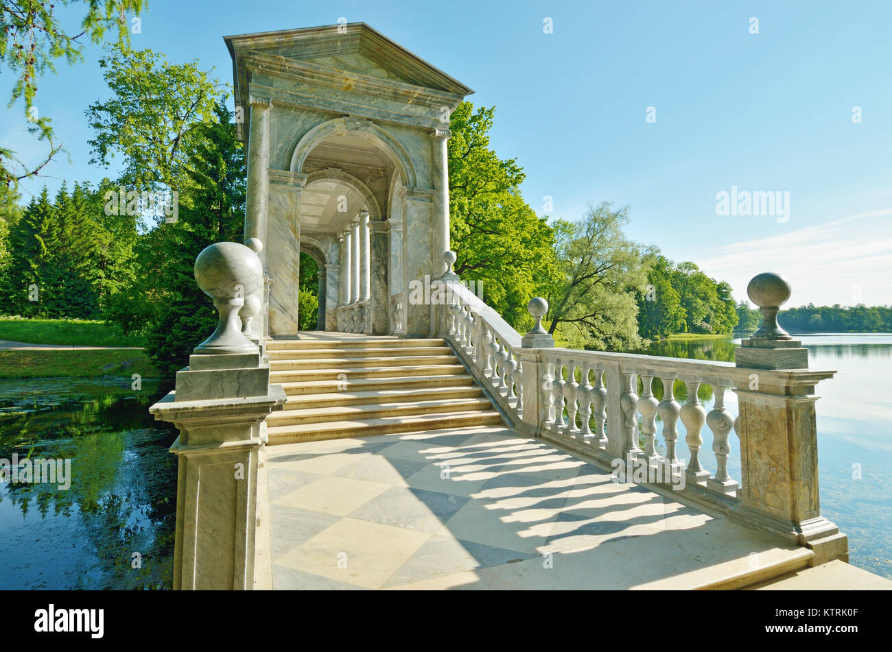 A beautiful marble bridge on the lake has a classic architectural ...