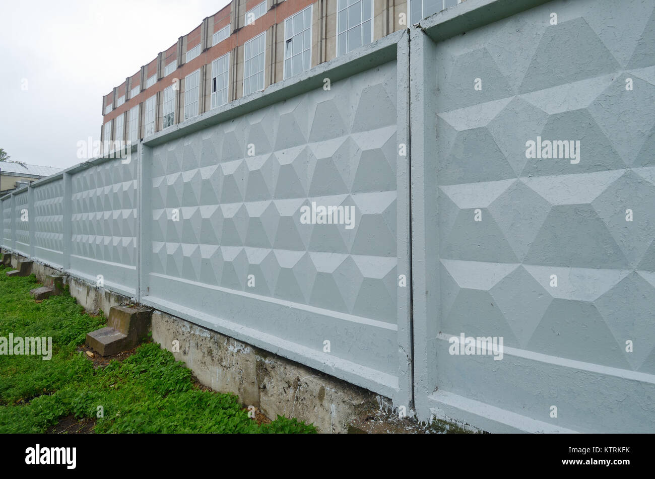 Around the factory has built a high concrete fence Stock Photo - Alamy