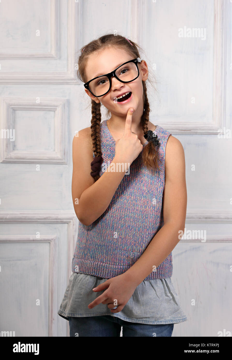 Happy thinking kid girl in fashion glasses with excited emotional face ...