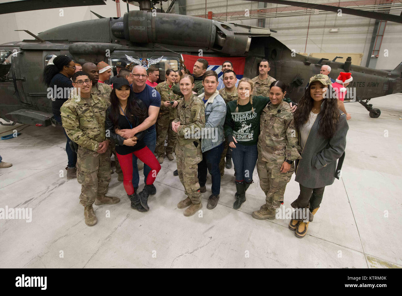 U.S. soldiers pose with wrestler Gail Kim, professional chef Robert ...
