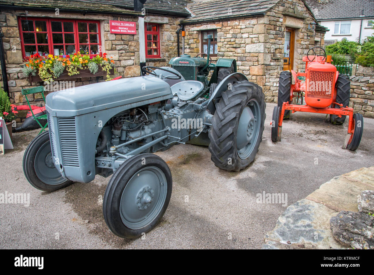 Two antique tractors on display in front of store in Dent, Yorkshire ...