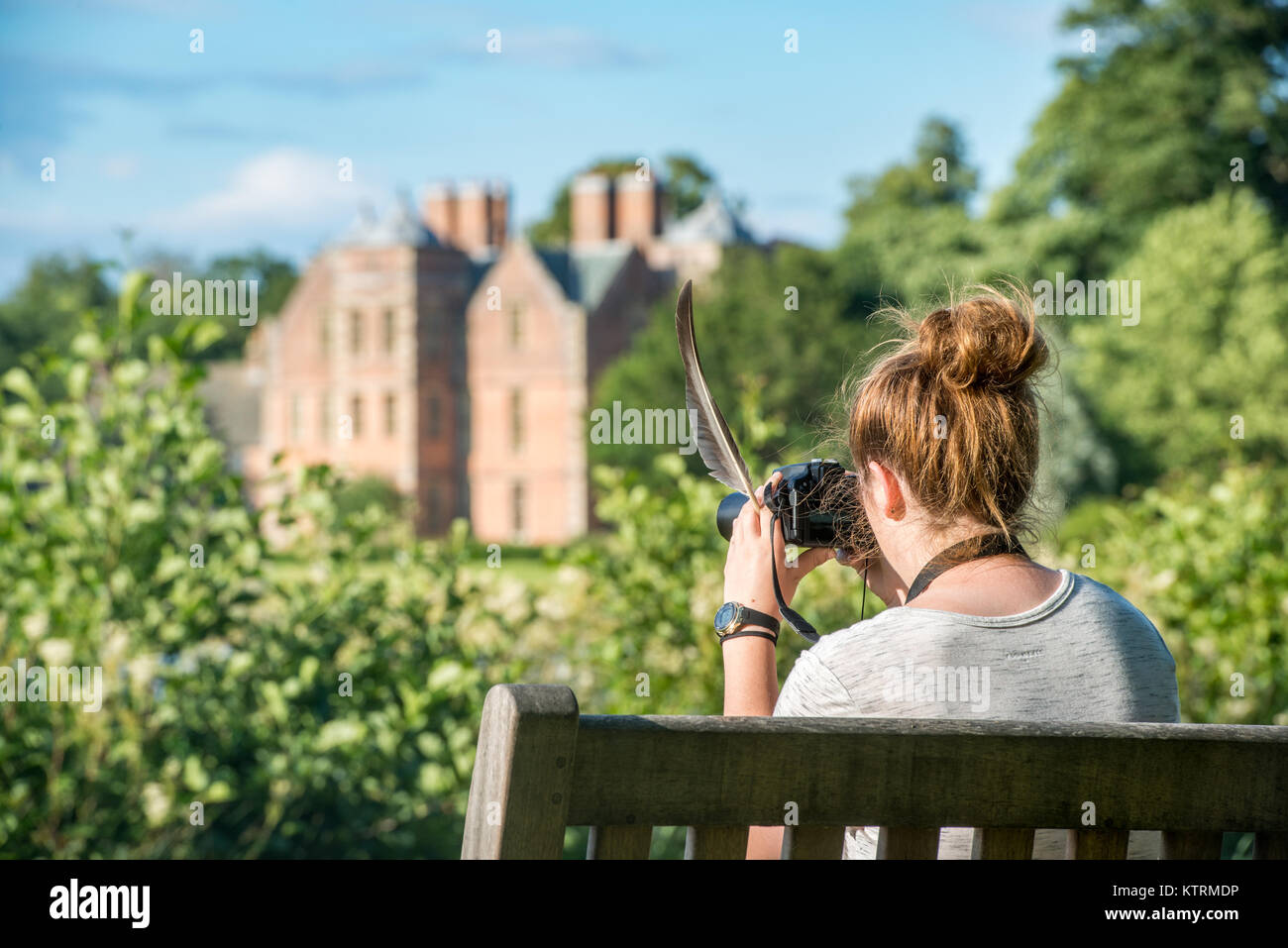 Female photographer holding feather takes photo of Kiplin Hall, Scorton ...