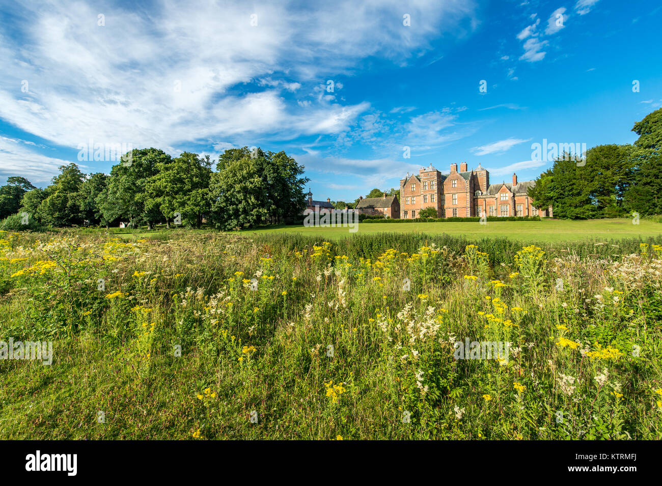 Dramatic sky hangs above Kiplin Hall and field of wildflowers, Scorton ...