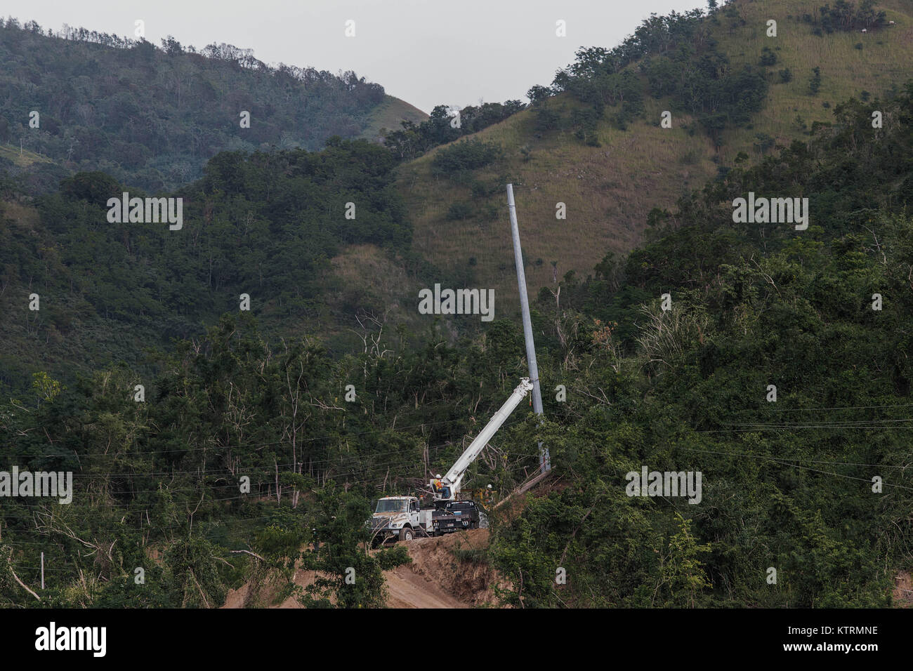 Lineman repair a damaged powerline in the aftermath of Hurricane Maria ...