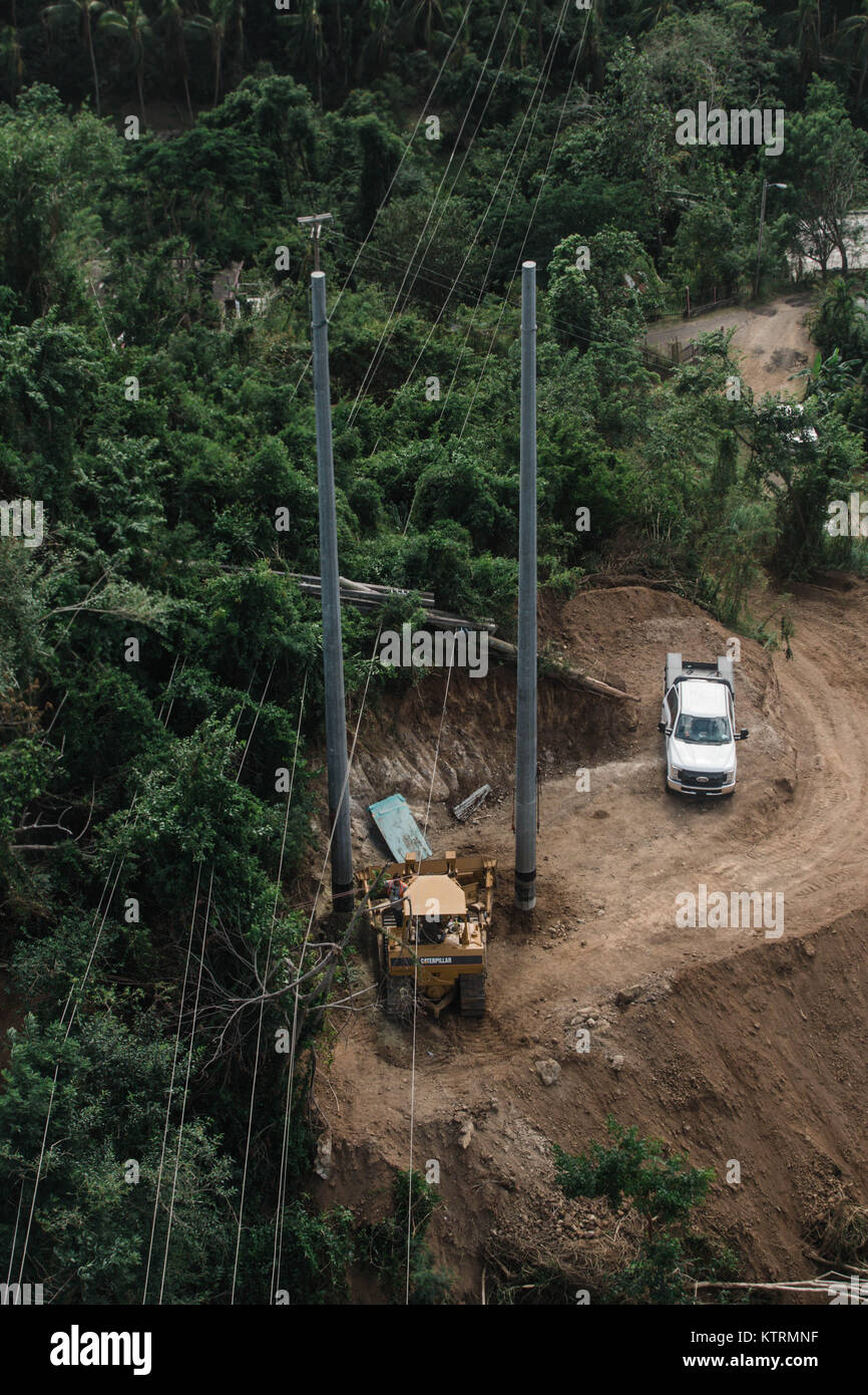 Lineman repair a damaged powerline in the aftermath of Hurricane Maria ...