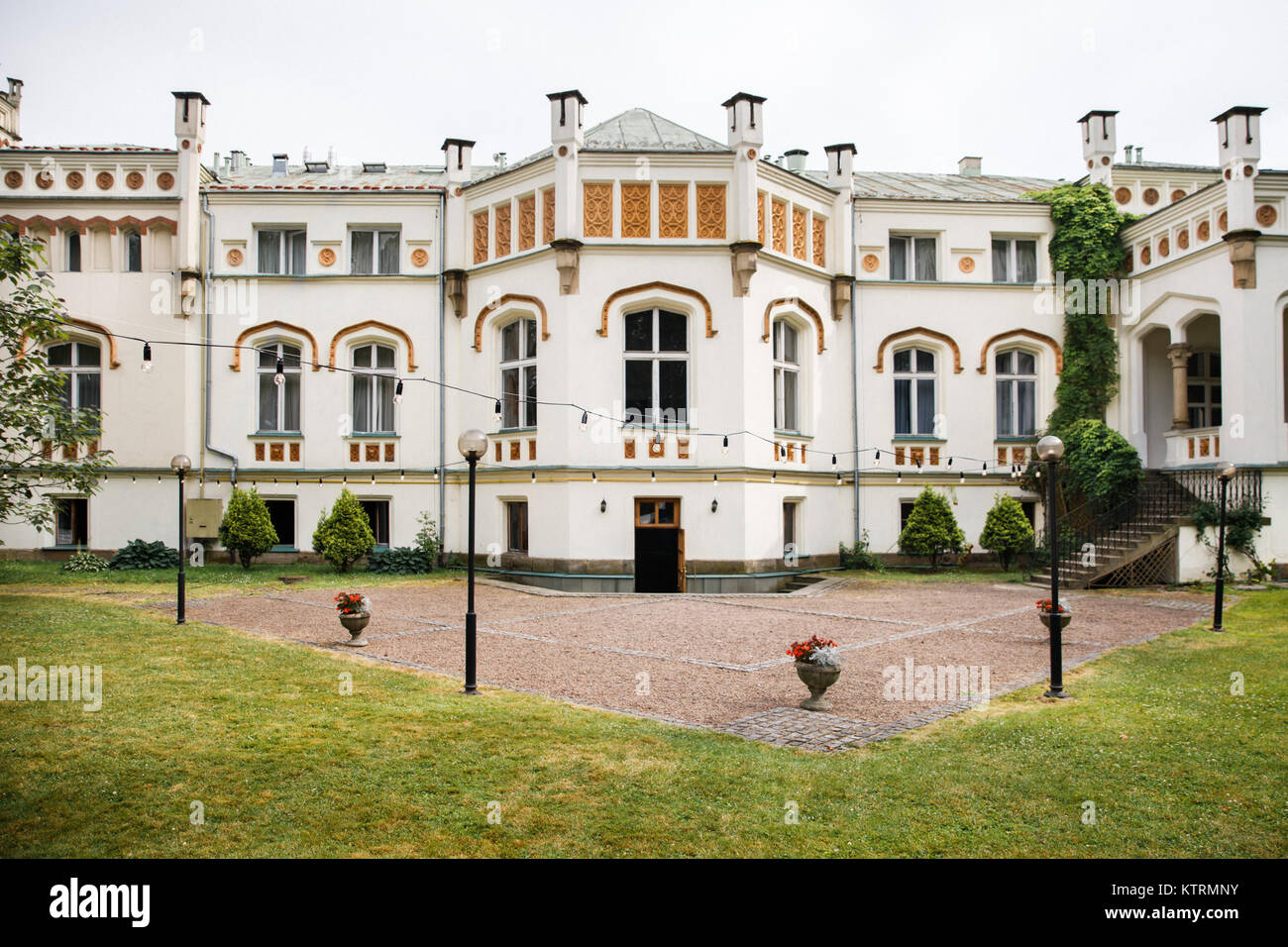 Exterior of a beautiful old house with green lawn Stock Photo - Alamy