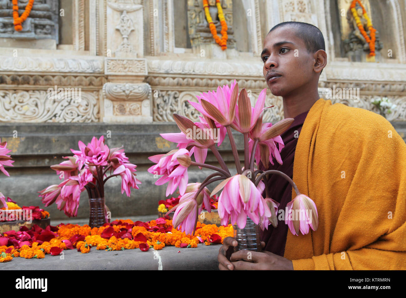 Portrait of a Buddhist Monk with an offering of lotus flowers at the ...