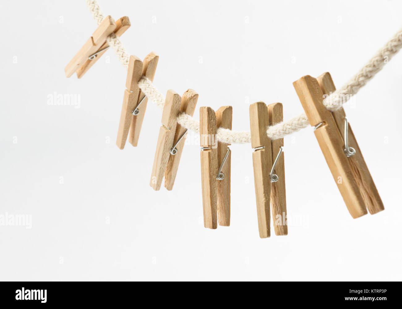 Clothes clips on a rope isolated on white background - loundry peg on ...