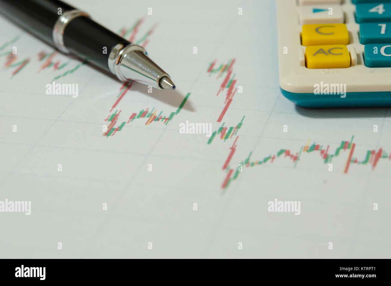 Graph and pen and calculator Stock Photo - Alamy