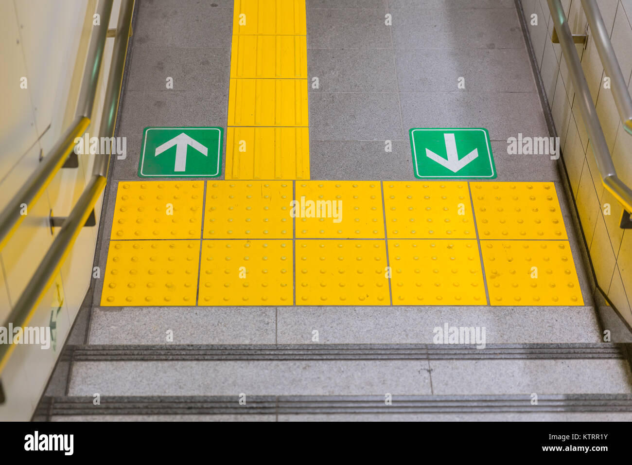 Walkway with direction arrow and disabilities people yellow pavement in ...