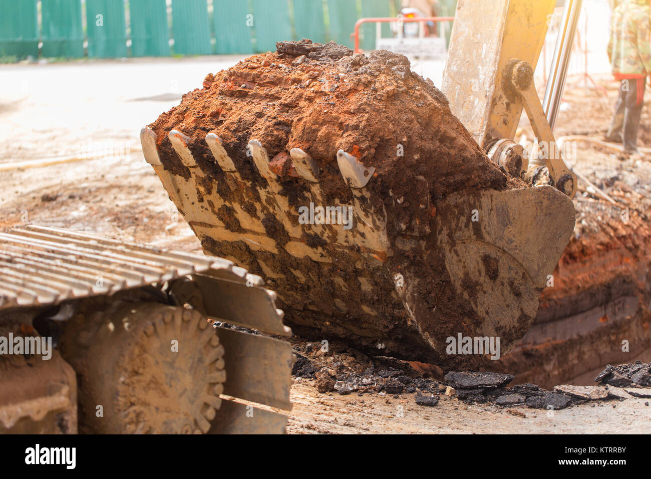dirty backhoe construction site excavator with digging land soil on ...