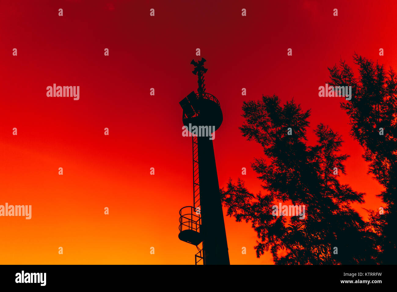 Silhouette of tsunami wave Warning Tower or beach guard tower at sunset ...