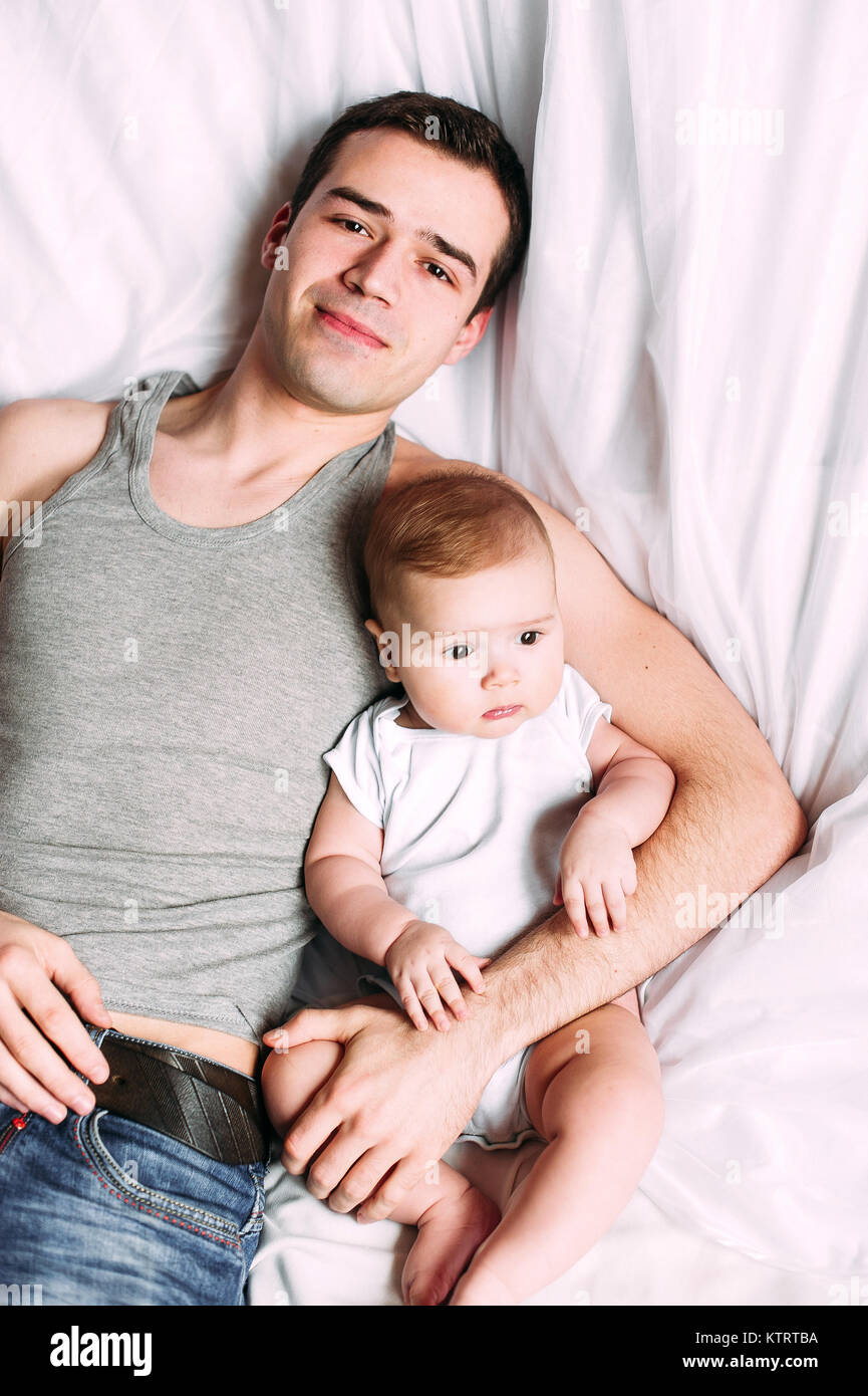 Portrait of loving father with baby boy 4-6 months his son at home on ...
